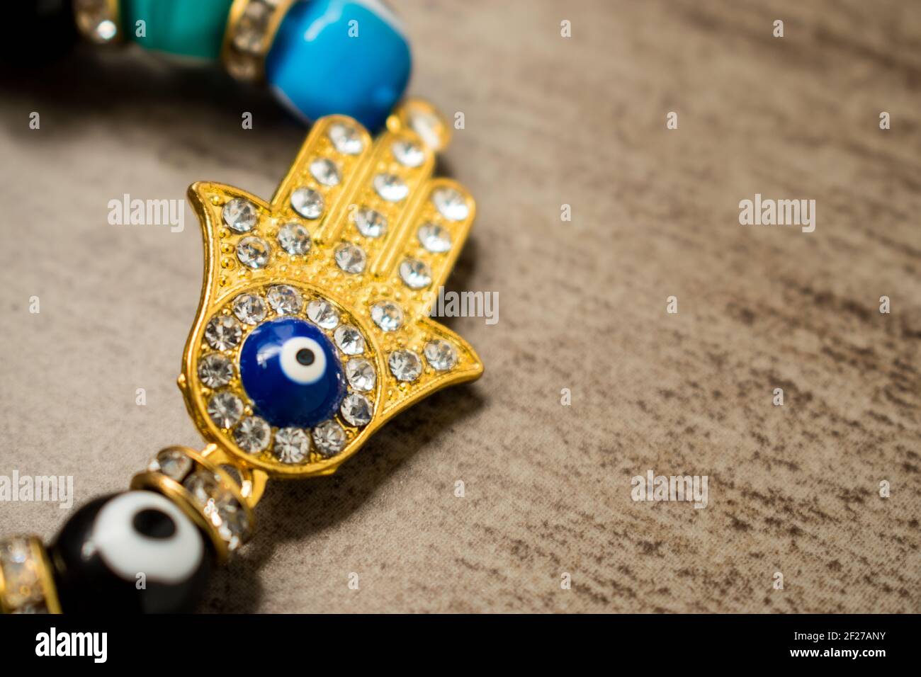 Asian golden protector symbol in a colorful craft on a bright wooden ...