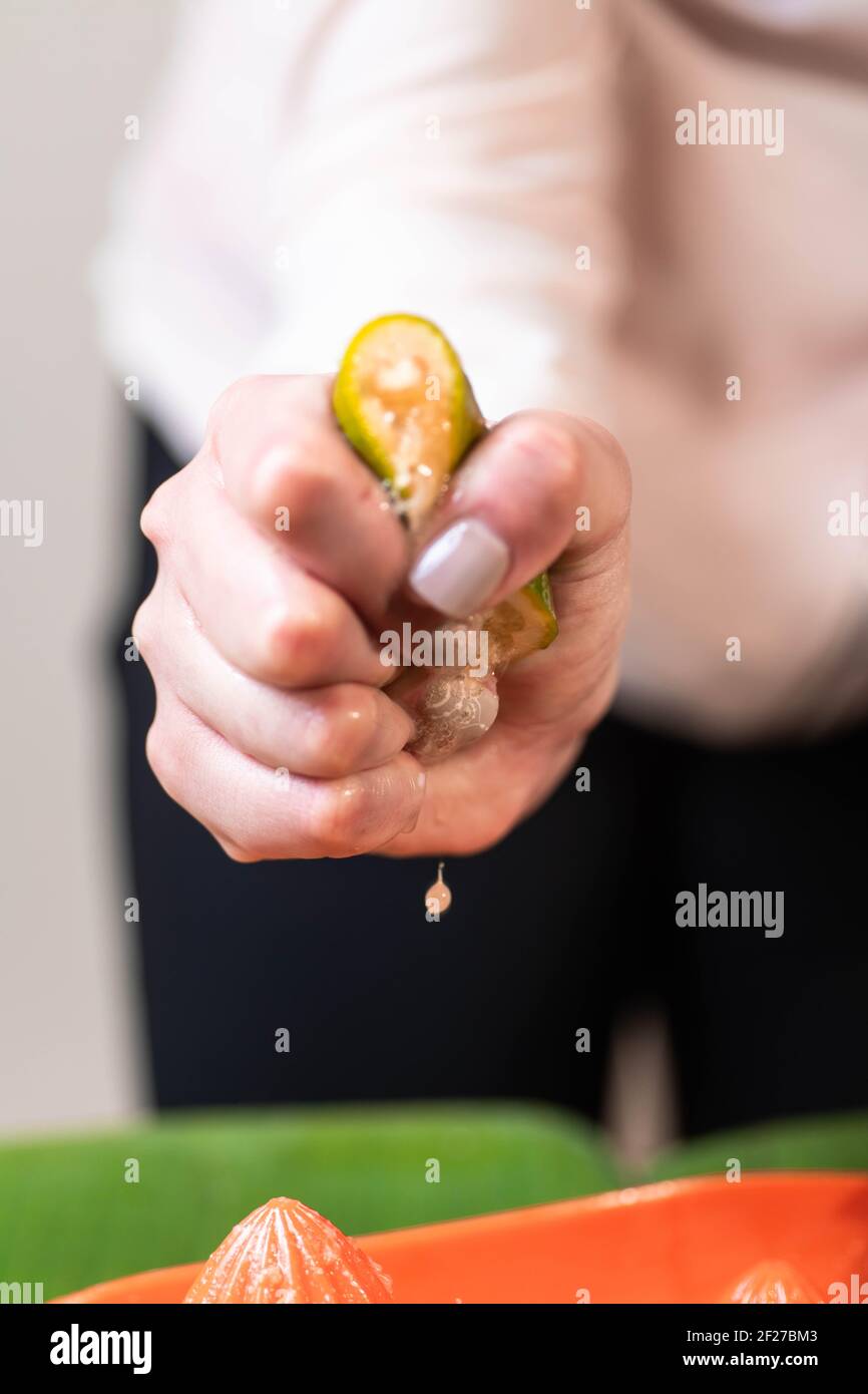 chef squeezing lime with his hand Stock Photo - Alamy