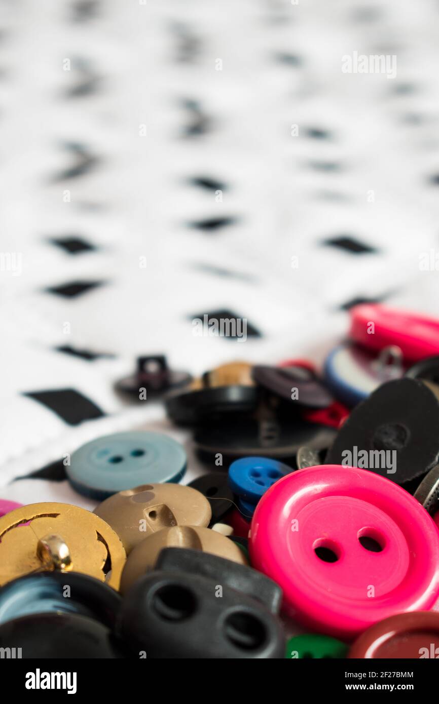 Some different colorful buttons on white, big and soft surface with ...