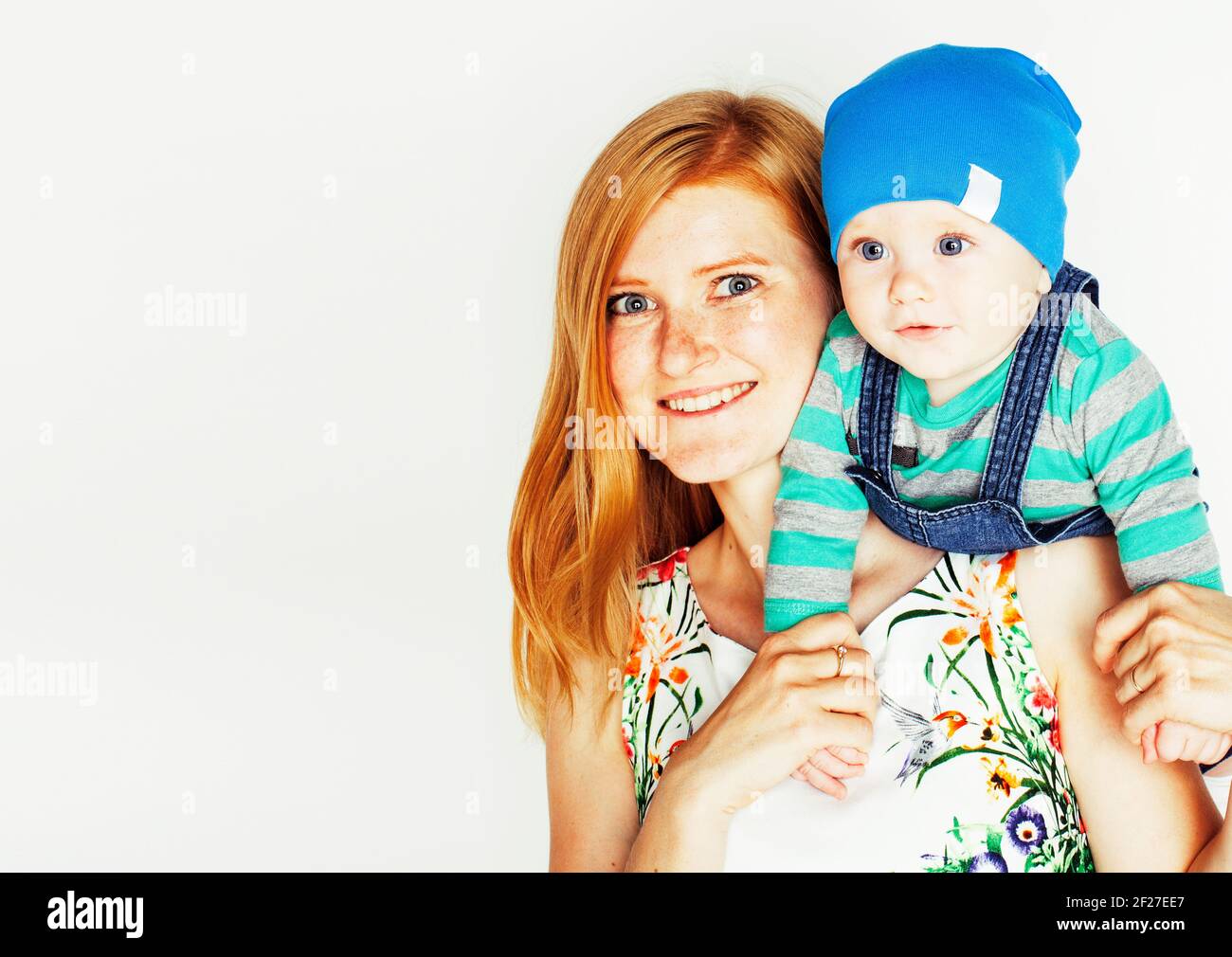 young beauty mother with cute baby, red head happy modern family ...