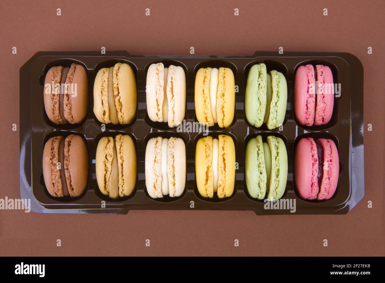 Maccarones in plastic packaging photographed from above on a brown ...