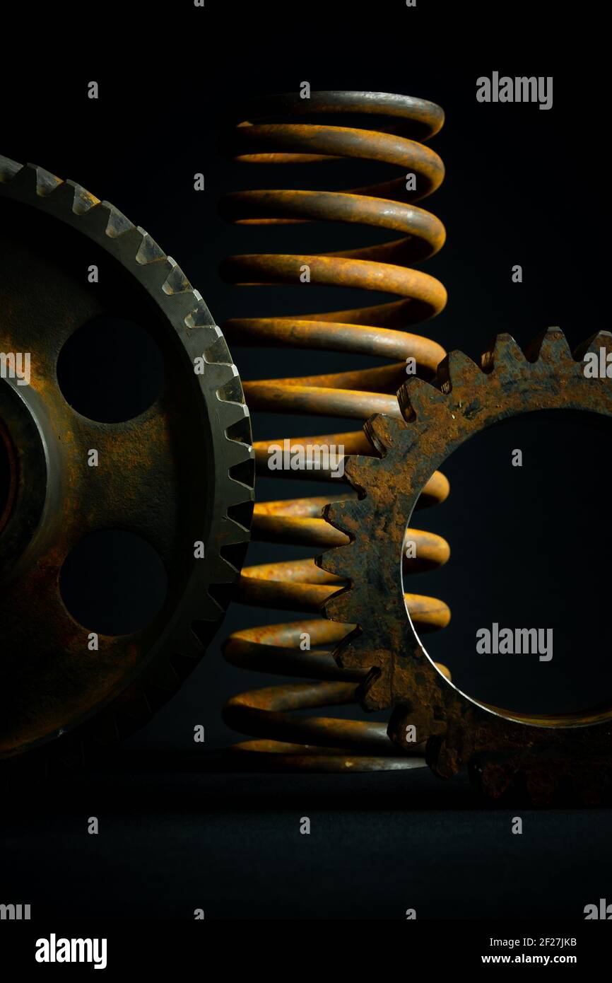 Rusted spring and gears with black background Stock Photo - Alamy