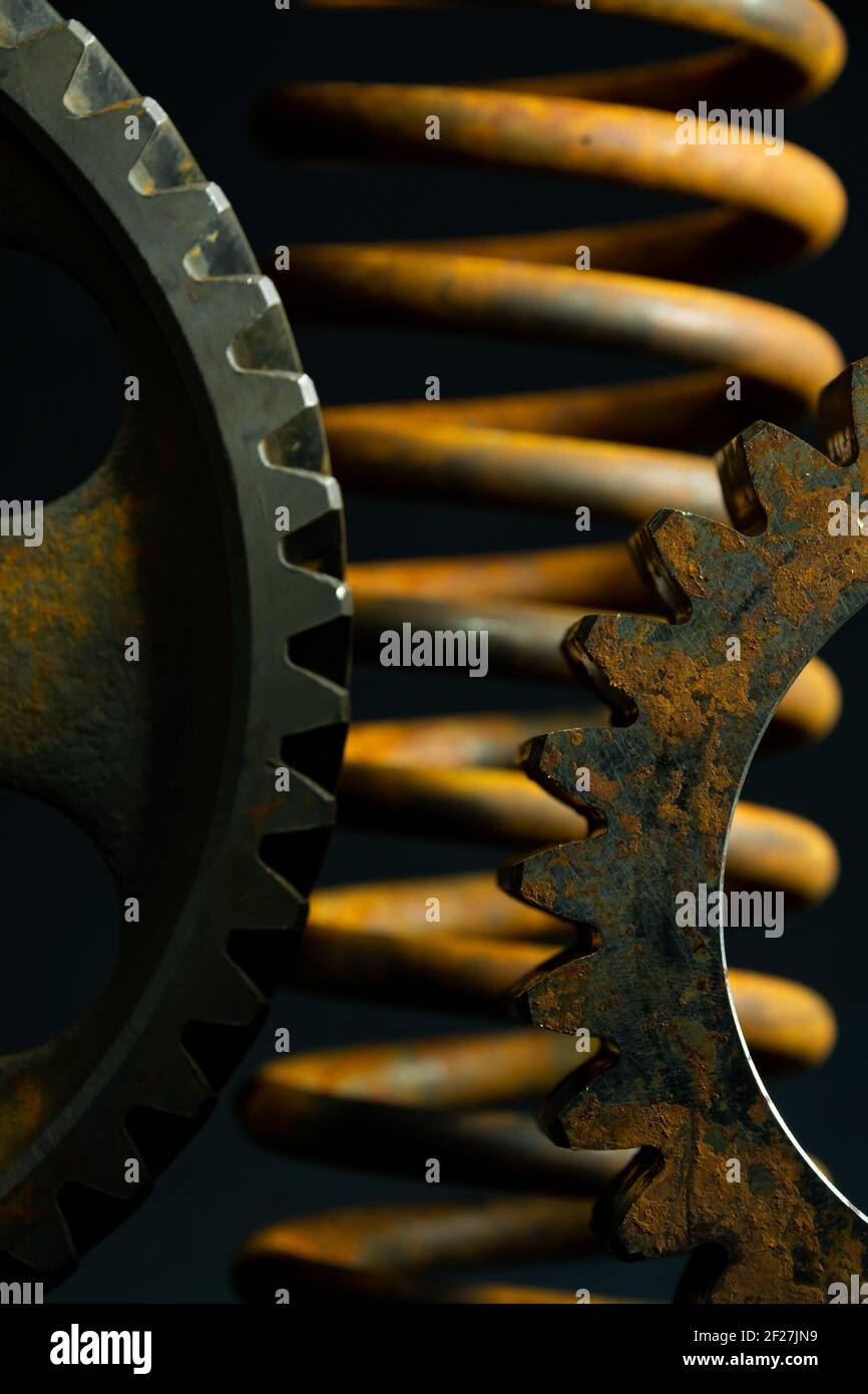 Rusted spring and gears with black background Stock Photo - Alamy