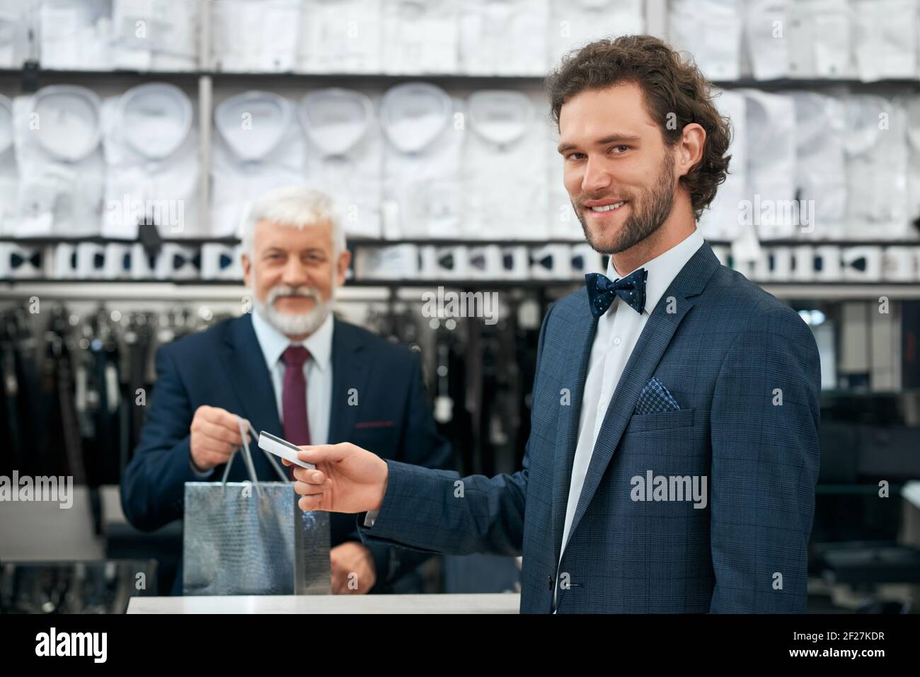 Satisfied customer making purchase and calculated by card in store for ...