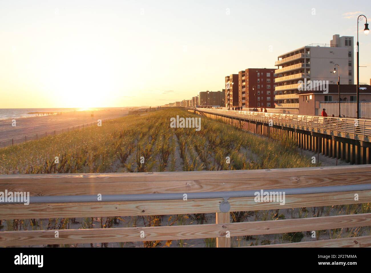 Sunset over Atlantic Ocean from Boardwalk ramp Long Beach Stock Photo ...