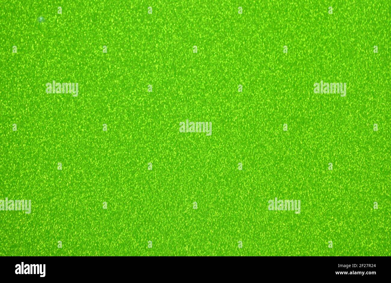 Acid green monochrome background with fine golden sparkles with a blur ...