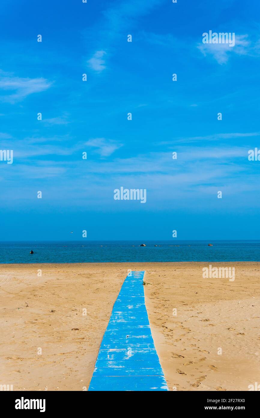 A vertical shot of the beach under a blue sky on a sunny day Stock ...
