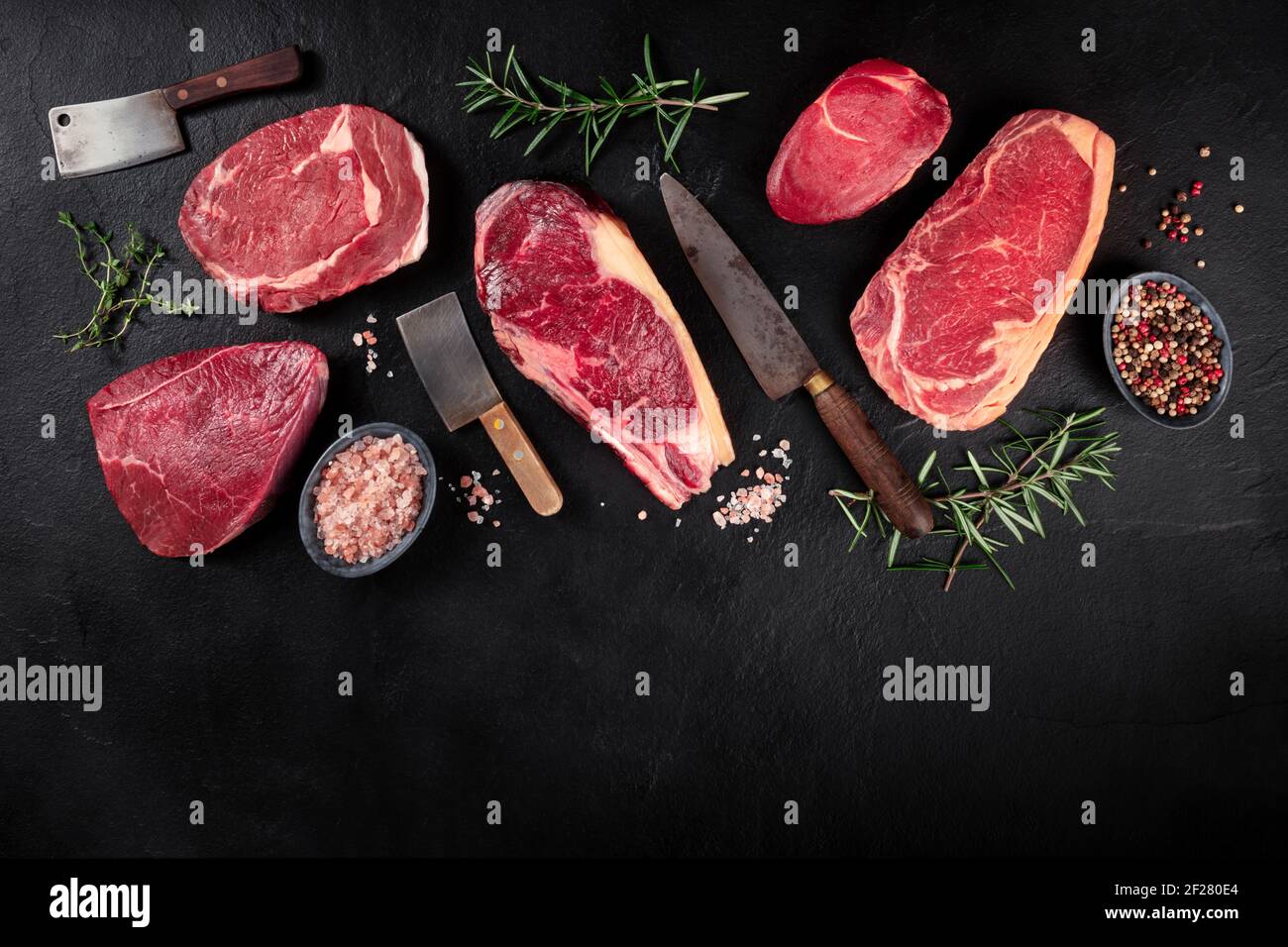Meat banner with copy space. Different beef steaks, shot from the top ...