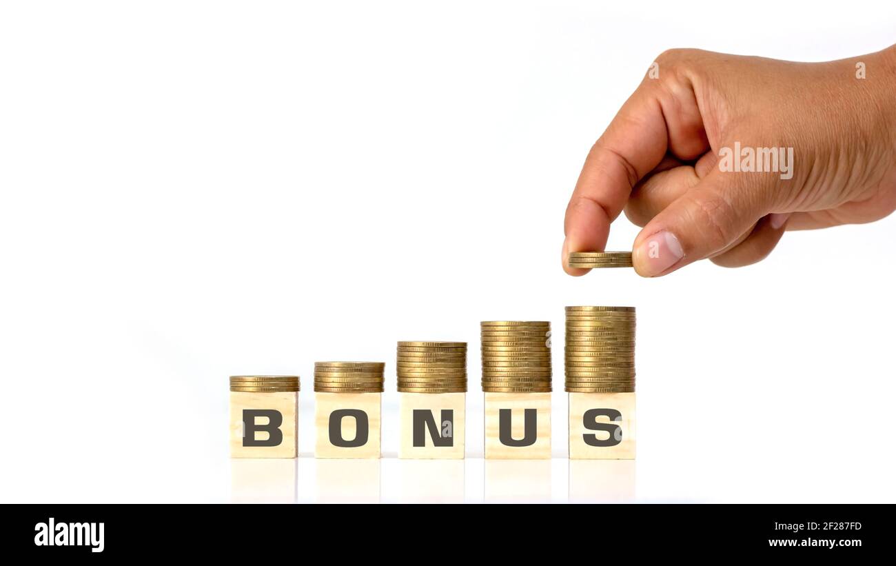 Coin and coin hand held on square wooden block with bonus message ...