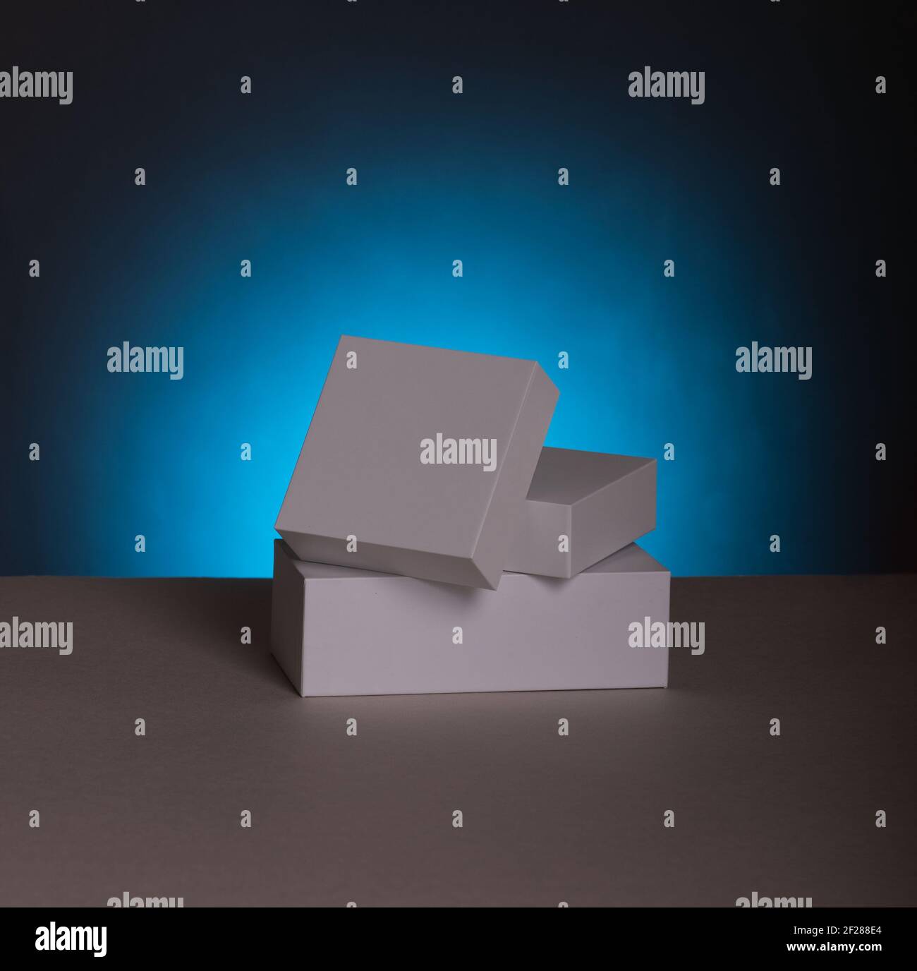 White gift boxes. Blank gift boxes and gift bags on blue background ...
