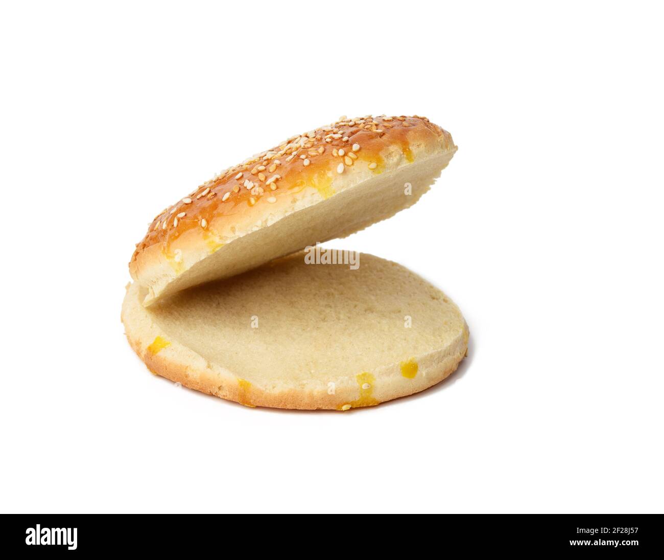 Baked sesame seed round bun for burger, bun cut in half Stock Photo - Alamy