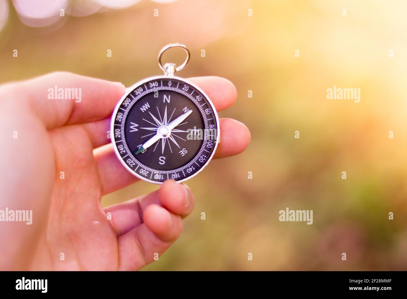 Adventure: Compass in manâ€™s hand, showing the direction Stock Photo ...