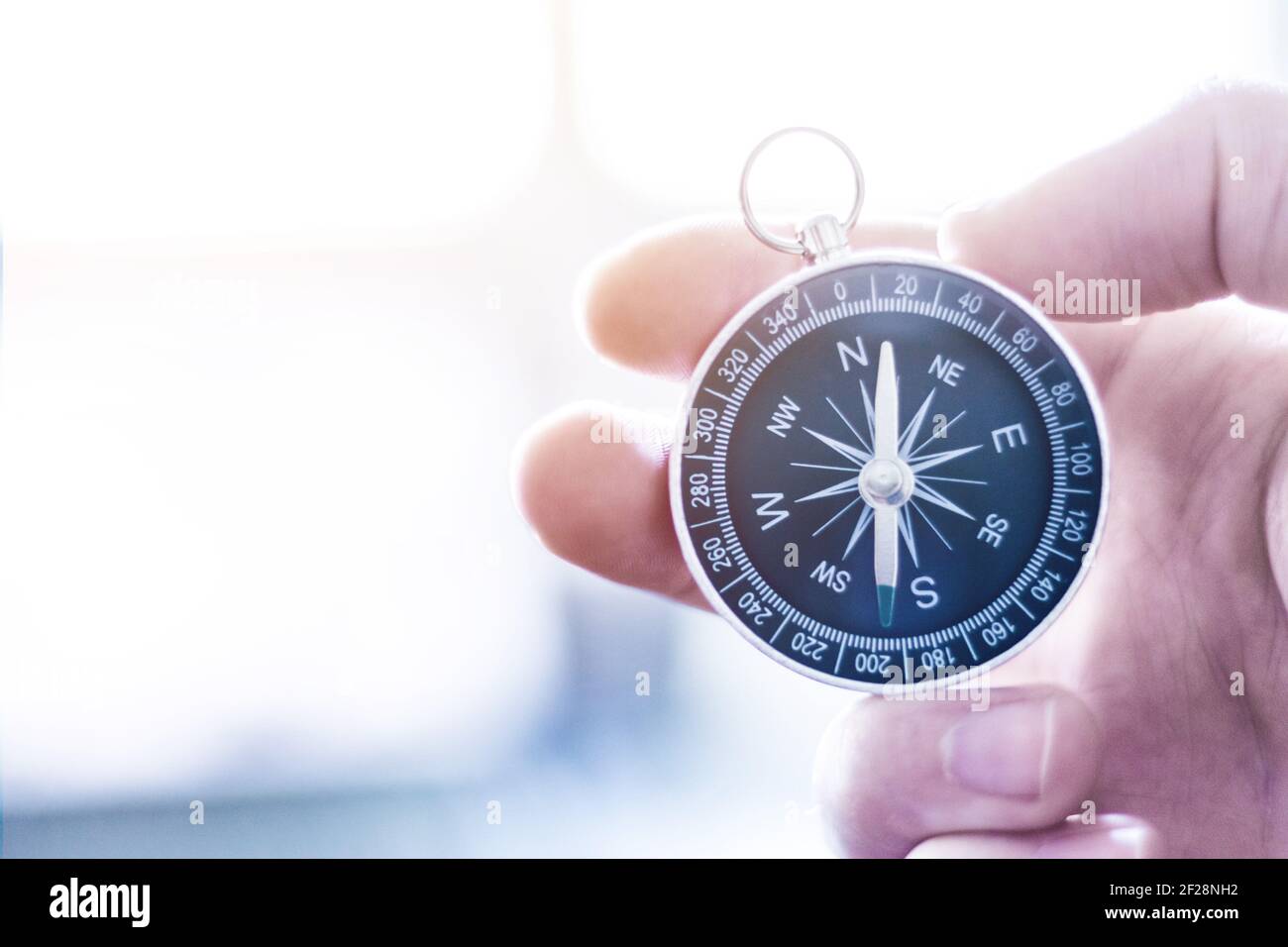 Innovation concept: Man is holding a compass in his hand, closeup ...