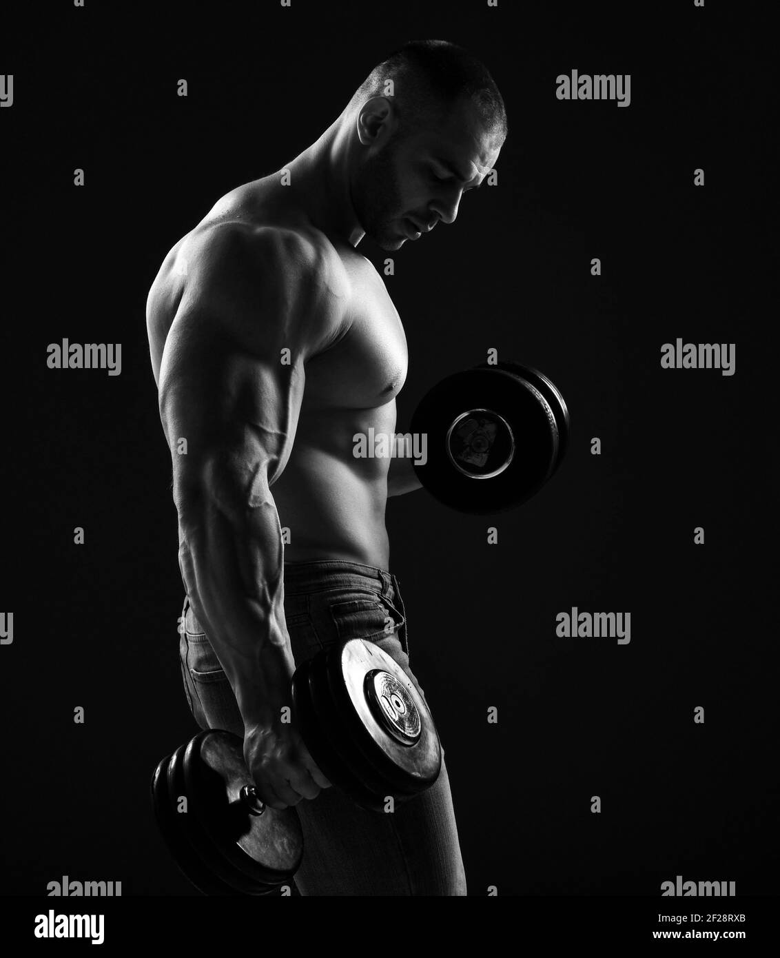 Muscular men bodybuilder is working out, lifting alternately two ...