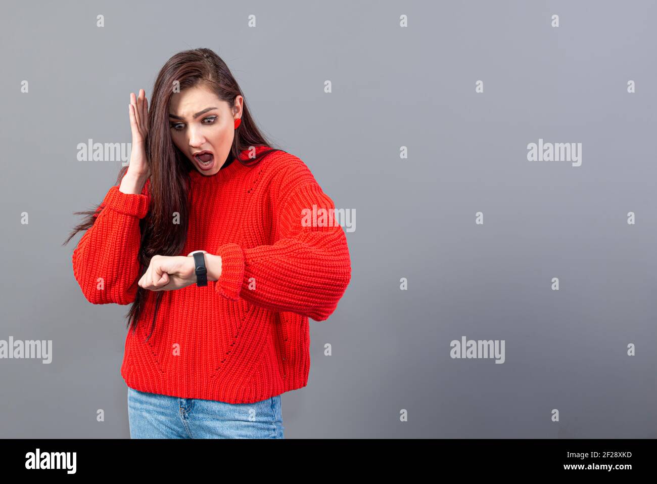 busy woman in red sweather worried looking at her wristwatch, female ...