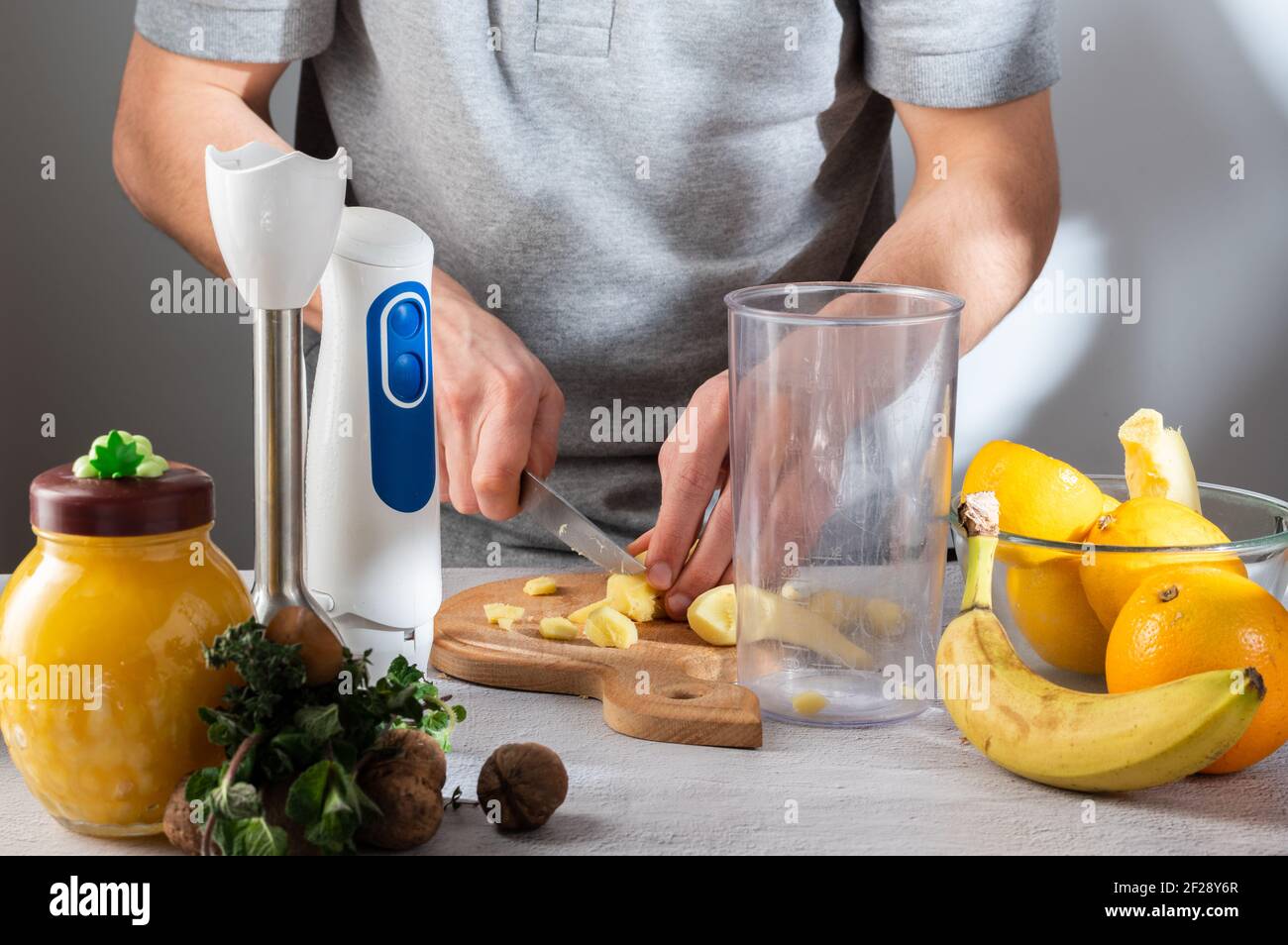 Cutting vegetables. Slicing ginger for tea. Slicing ginger root for a ...