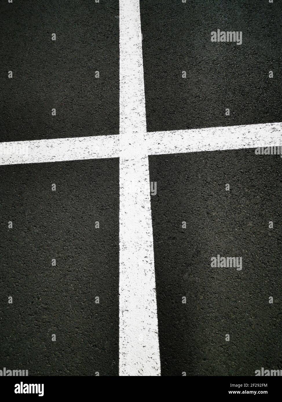 A vertical shot of white crossed lines on asphalt road Stock Photo - Alamy
