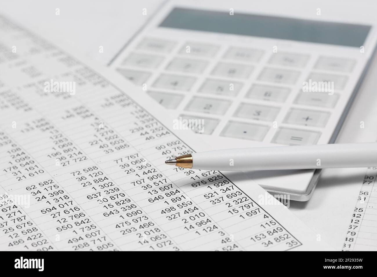 Financial accounting Pen and calculator on balance sheets Stock Photo ...