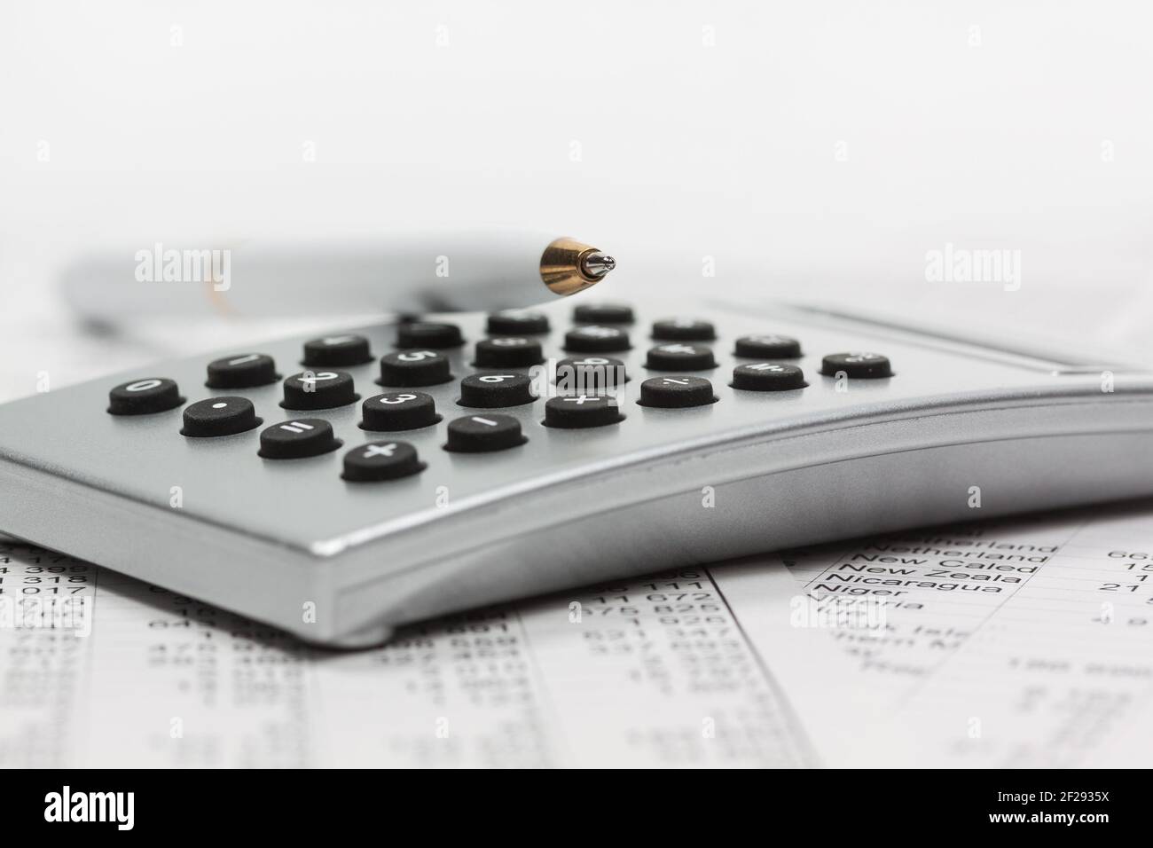 Financial accounting Pen and calculator on balance sheets Stock Photo ...