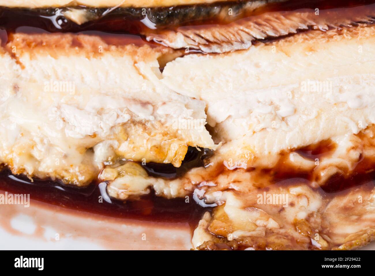Grilled trout fillet closeup dressed with delicious dark sauce. Macro ...