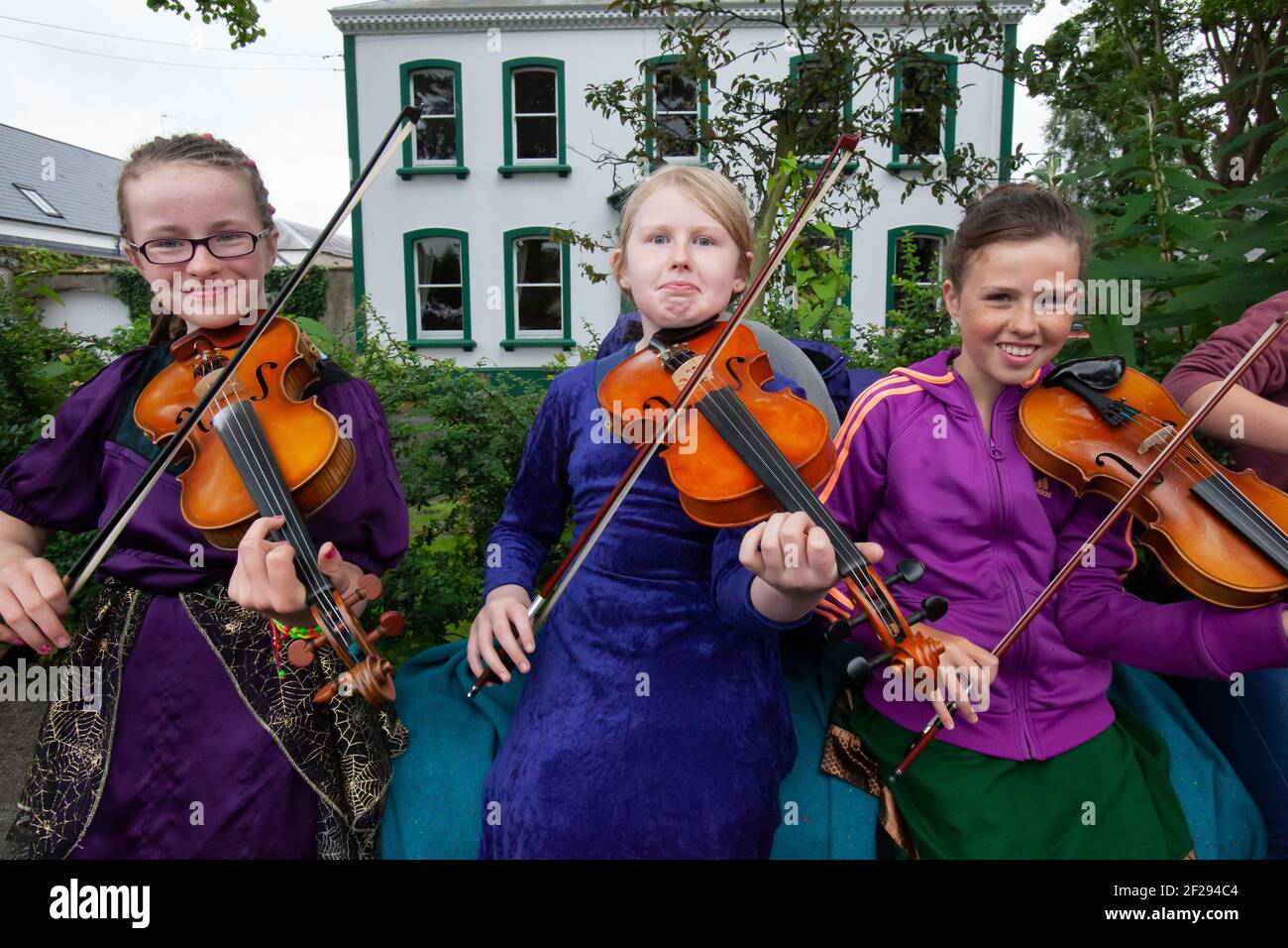 Three girls playing Irish music on violins at the Auld Lammas Fair ...