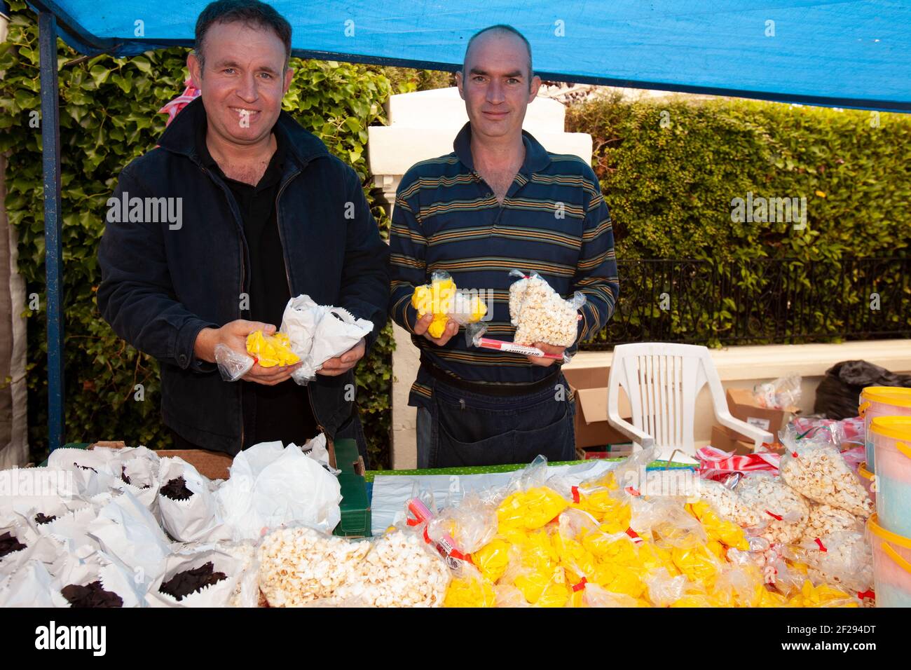 Two men selling the traditional delicacies of yellowman (honeycomb ...