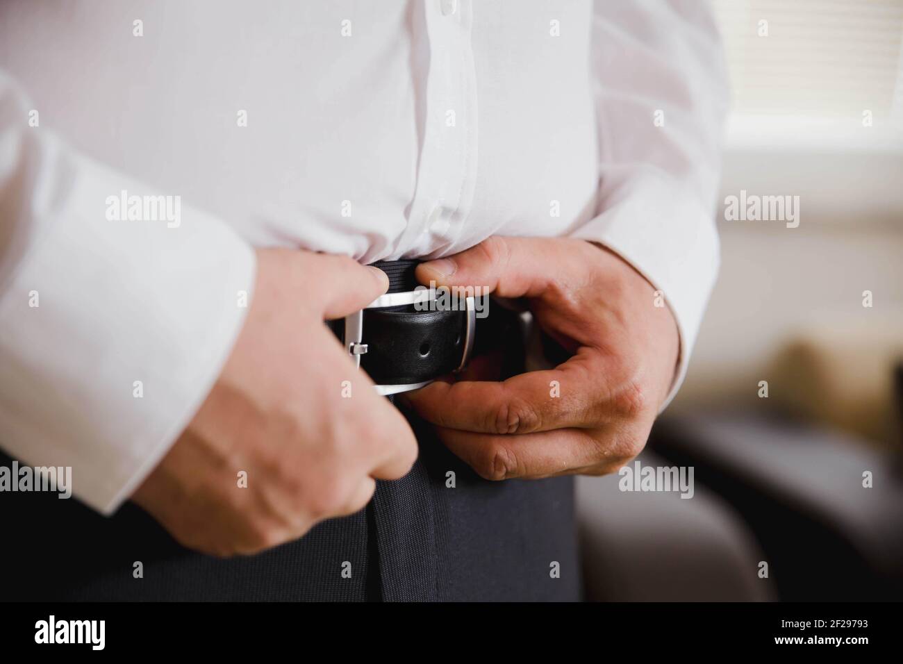 Man holding belt buckle hi-res stock photography and images - Alamy