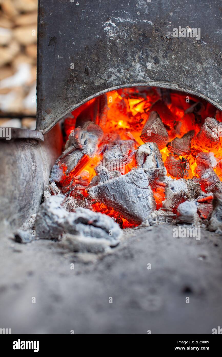 Burning coals in a metal grill for frying meat and vegetables. Cooking ...