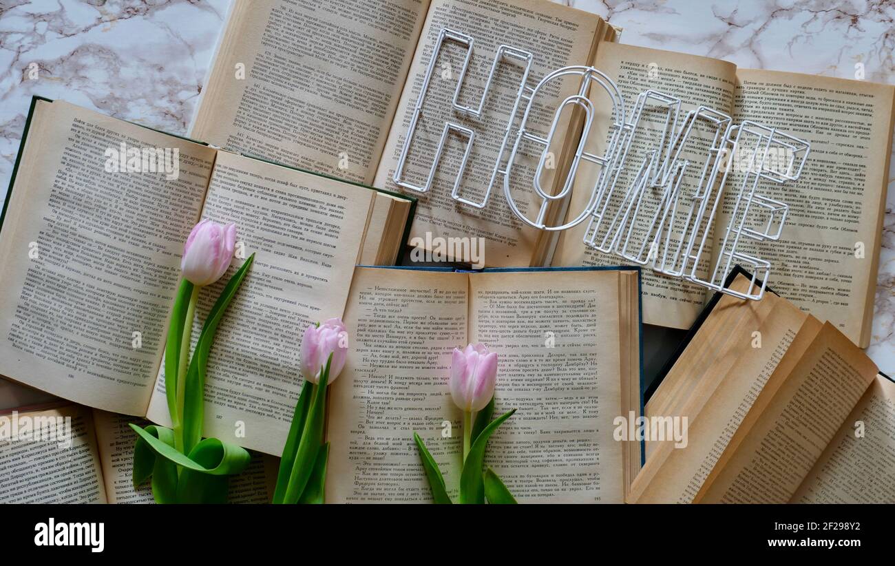 Spring flowers pink tulips on a book background at home. This photo is ...