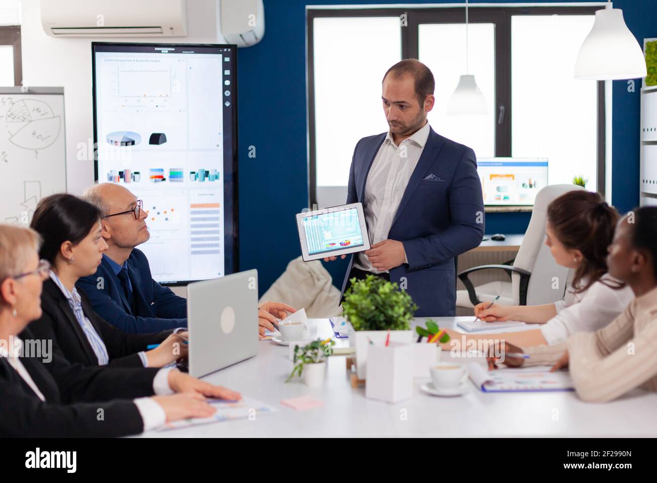 Succesful business man presenting the good evolution of company using ...