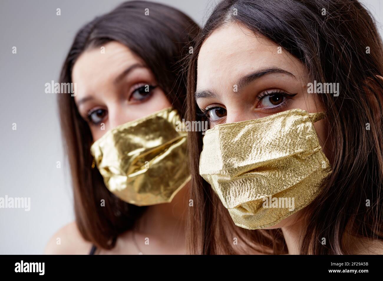 women wearing GOLDEN protective face masks watching you, young woman ...