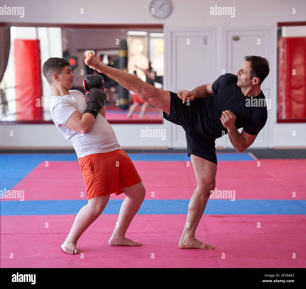 Overweight kickbox fighter sparring with his partner in the gym Stock ...