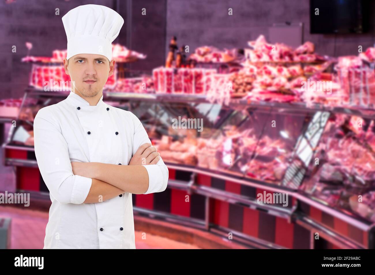 portrait of handsome male butcher, shopkeeper or cook posing in the ...