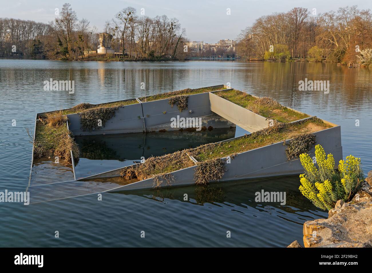 Early morning lights of dawn on the lake shore. Parc de la Tete d'Or is ...