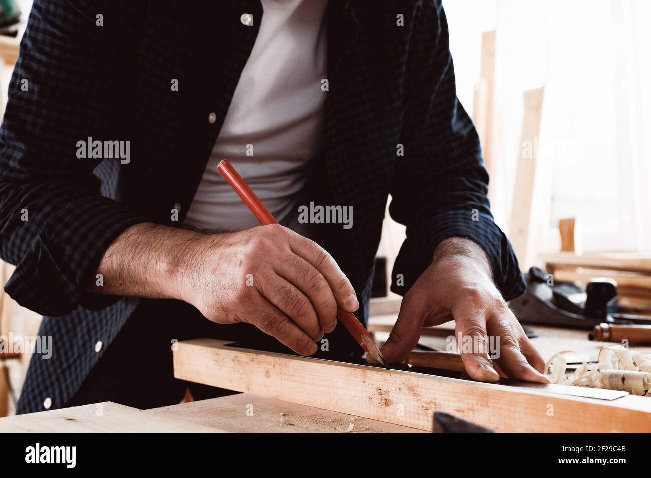 Carpenter makes pencil marks on a wood plank Stock Photo - Alamy