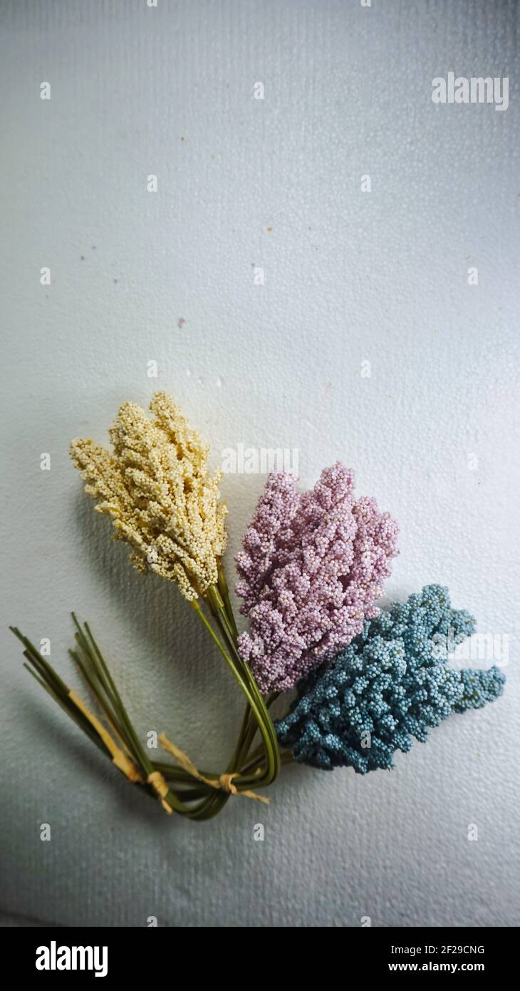 A top view of a colorful bouquet of artificial flowers on white ...