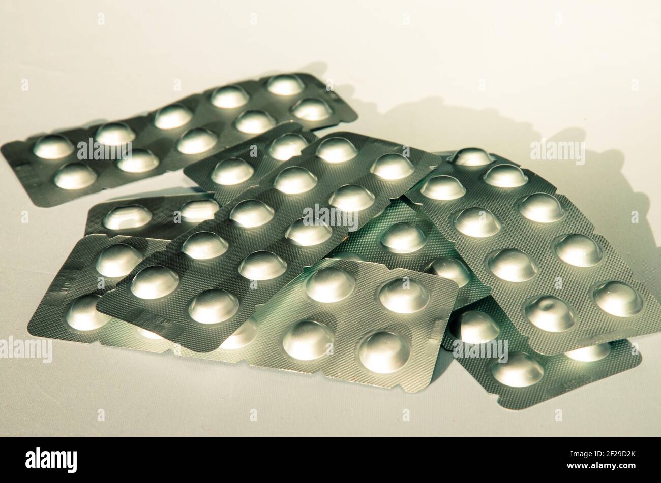 silver set of pills isolated on white image Stock Photo - Alamy