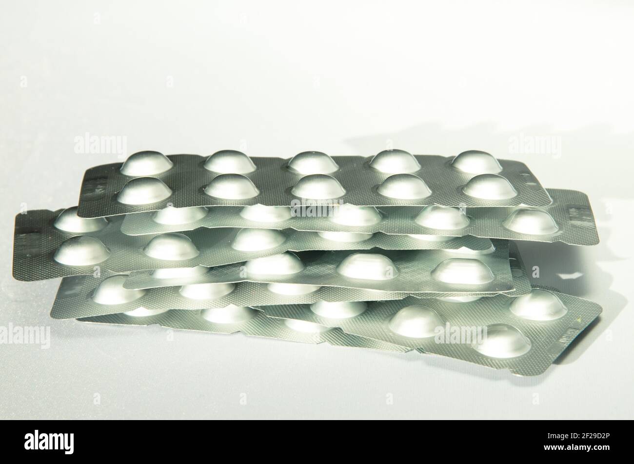 silver set of pills isolated on white image Stock Photo - Alamy