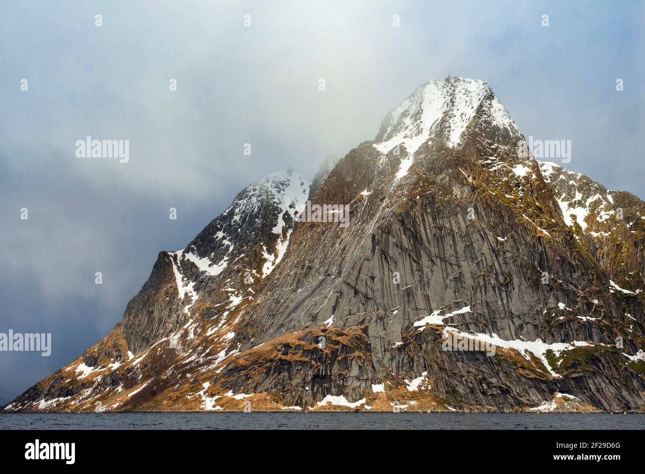 Landscape with the Olstinden peak mountain in Reine, Moskenes ...