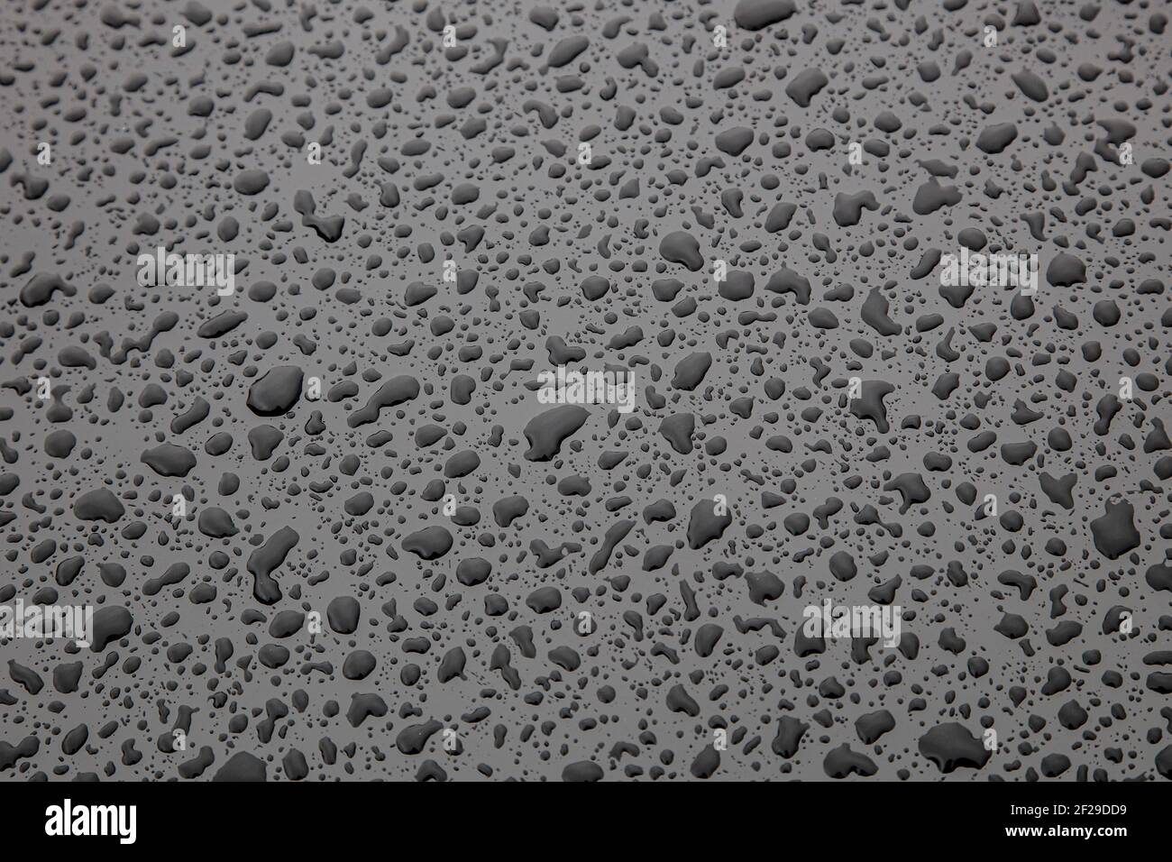 water drop on black metallic surface Stock Photo - Alamy