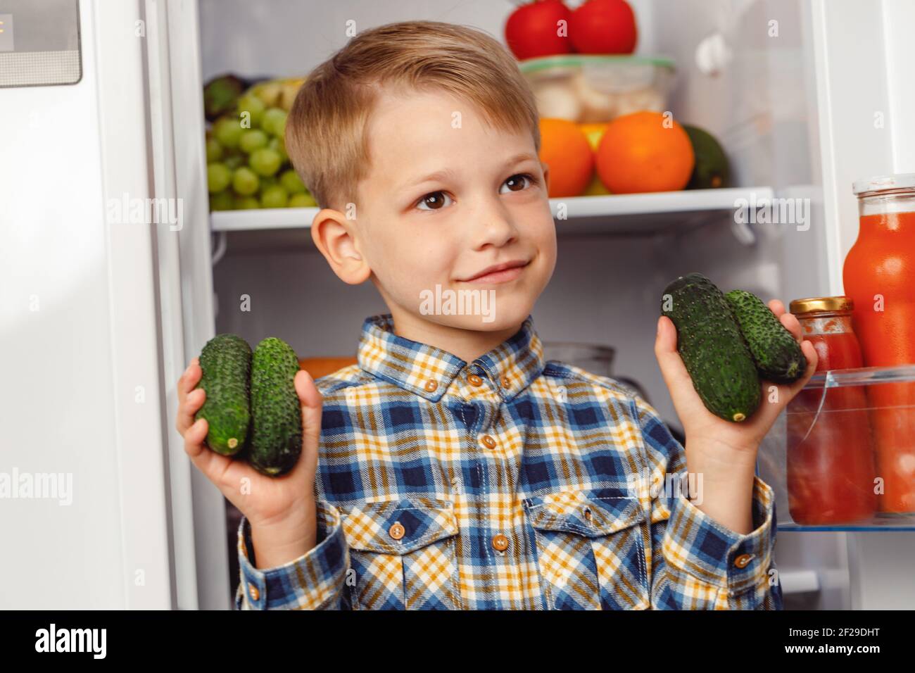 Little boy standing near the open fridge Stock Photo - Alamy
