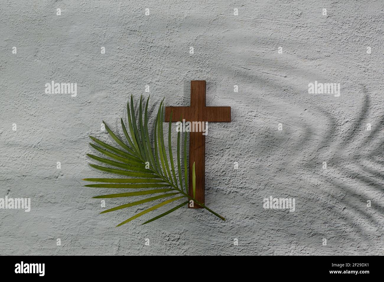 Palm sunday background. Cross and palm on grey background Stock Photo ...