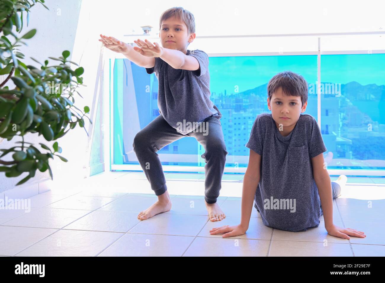 Boys doing sport exercises on balcony. Sport, healhty lifestyle, active ...