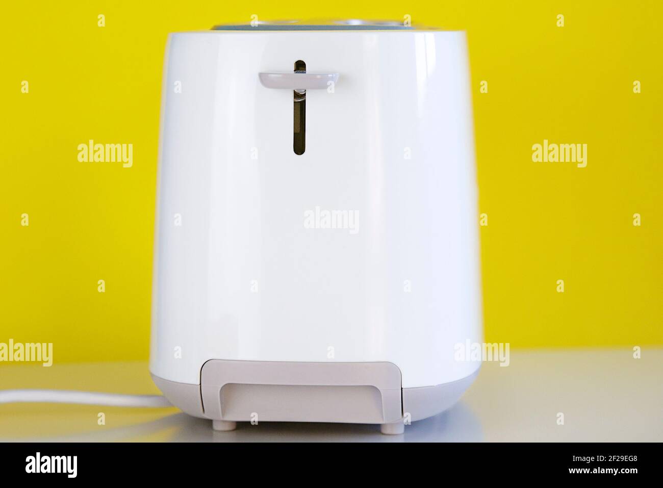 Toaster against yellow background Stock Photo - Alamy