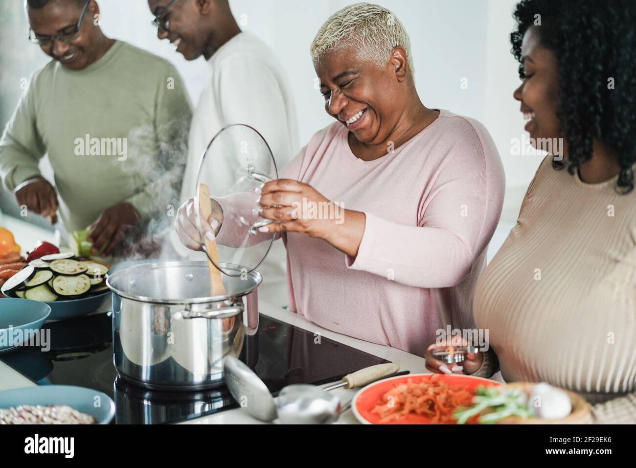 African woman with daughter cooking hi-res stock photography and images ...