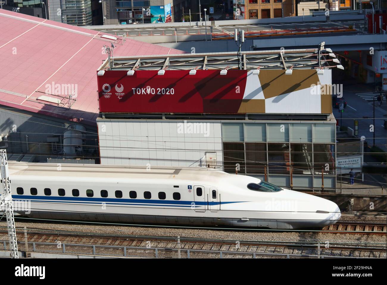 A bullet train passing Tokyo Sports Square which is decorated with the ...