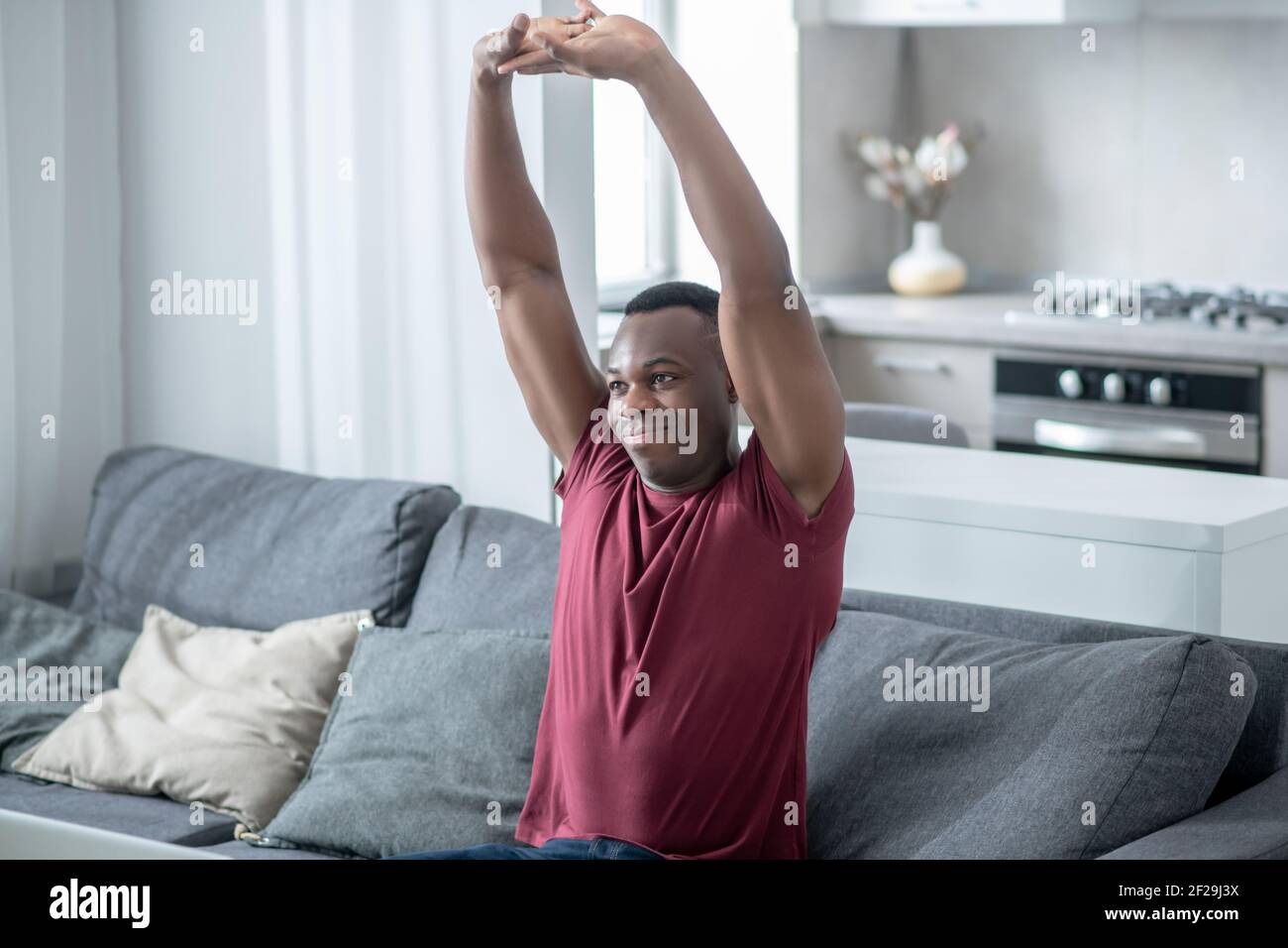 African american young man looking sleepy and stretching Stock Photo ...