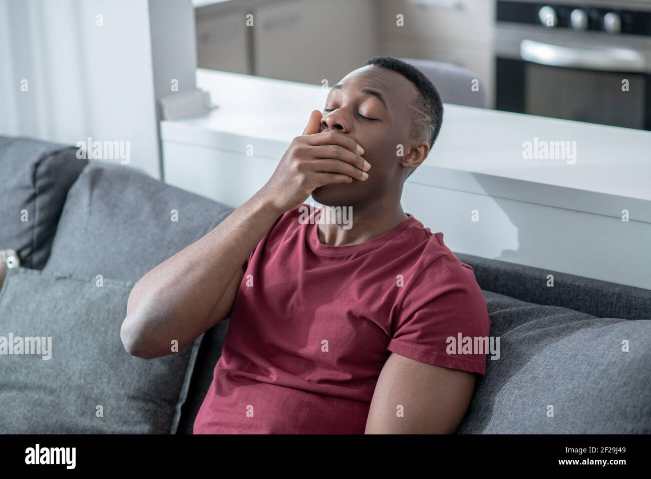 African american young man looking sleepy and yawning Stock Photo - Alamy