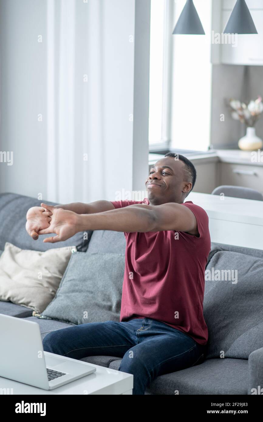 African american young man looking sleepy and stretching Stock Photo ...