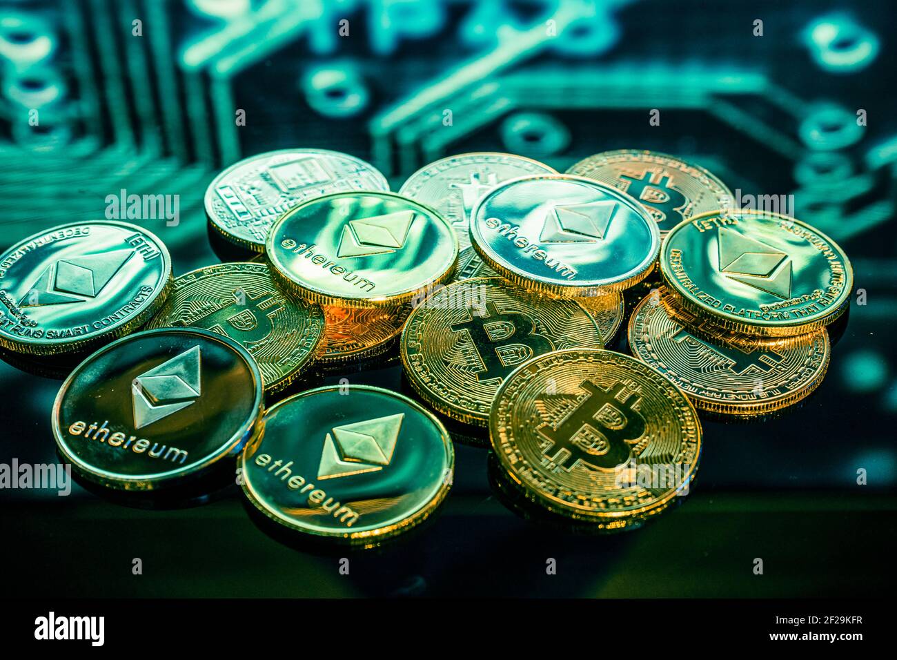 Bitcoin gold, silver and copper coins and defocused printed circuit ...